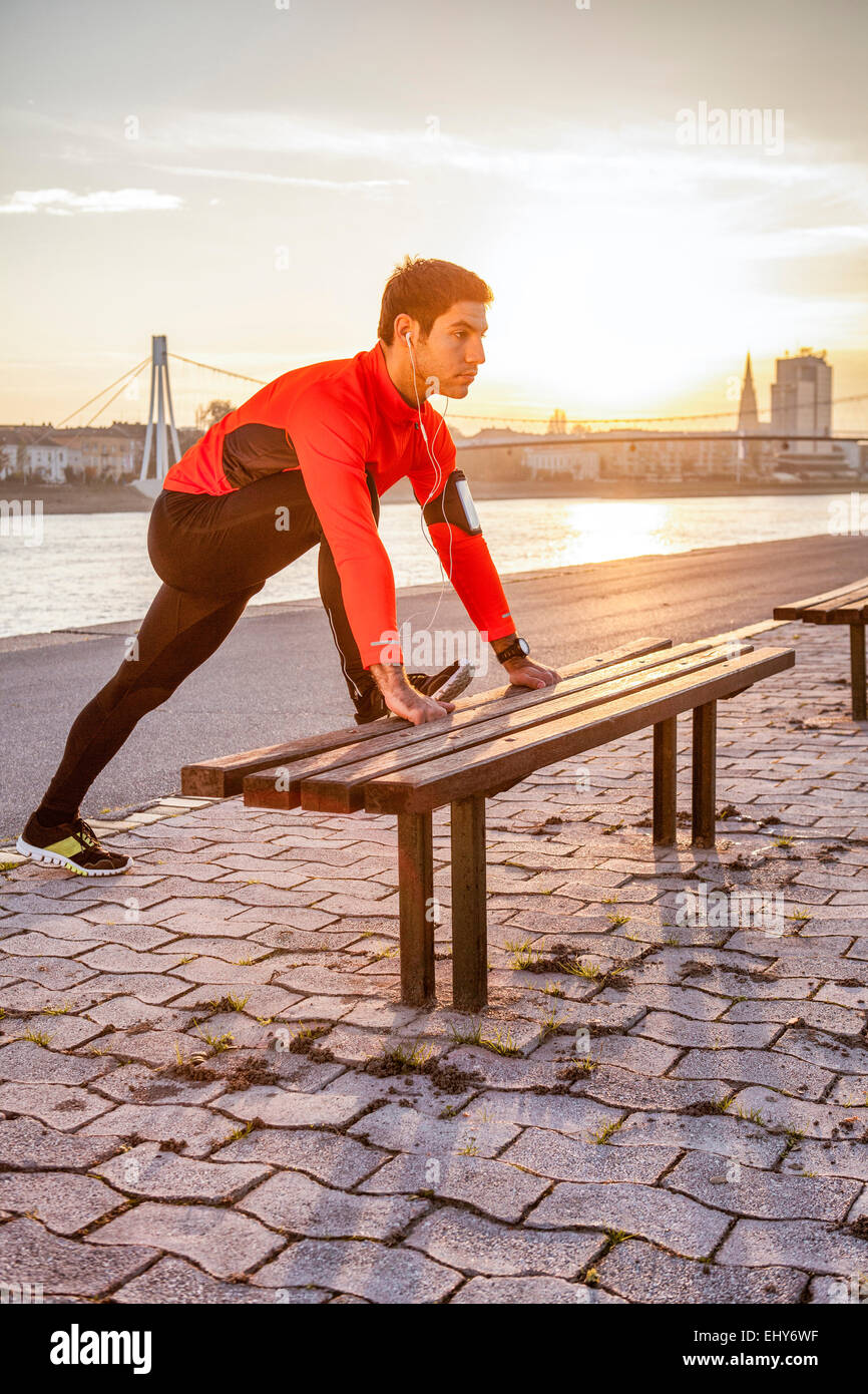 Male runner stretching and warming up at sunset Stock Photo - Alamy