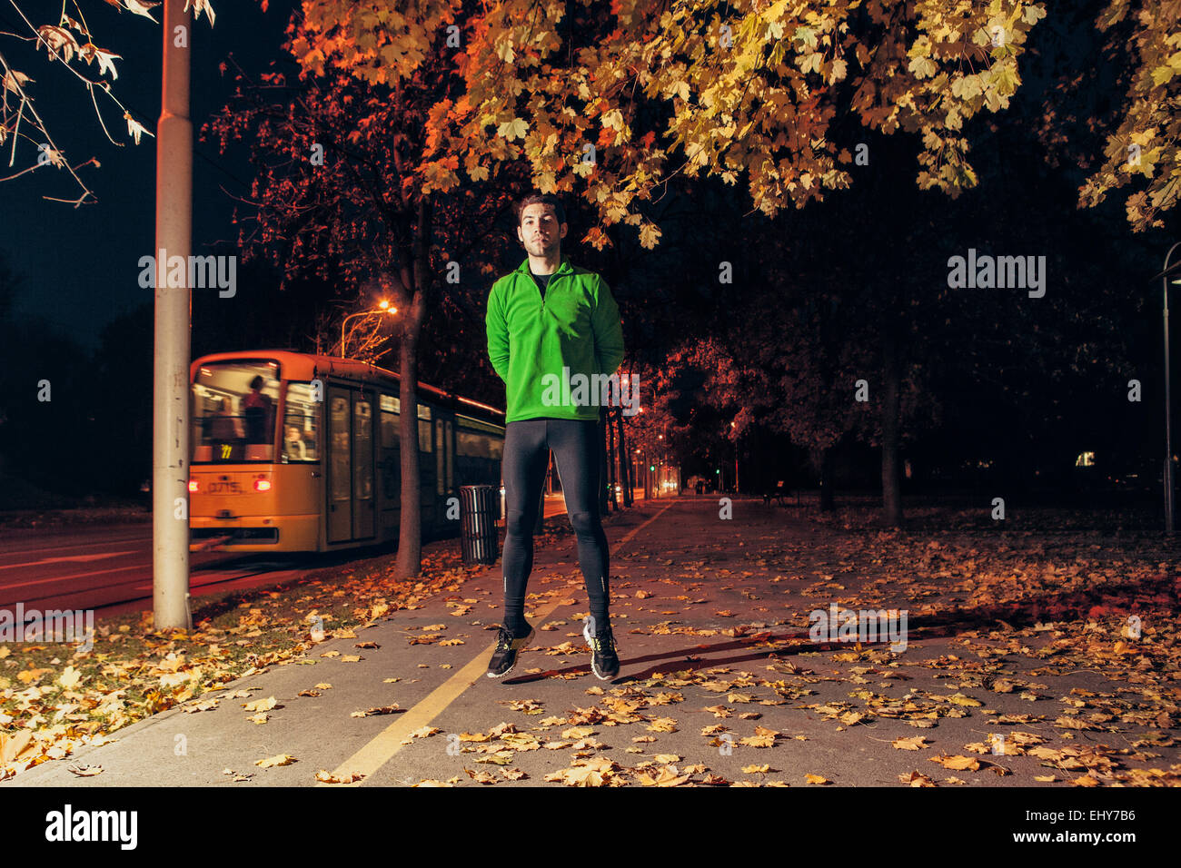 Male runner jumping and warming up at twilight Stock Photo - Alamy