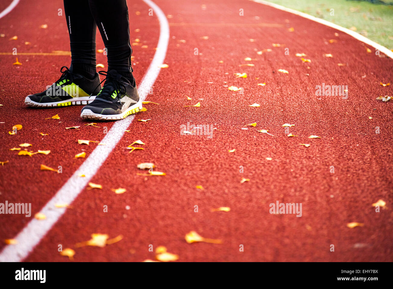 Male runner stands on running track Stock Photo - Alamy