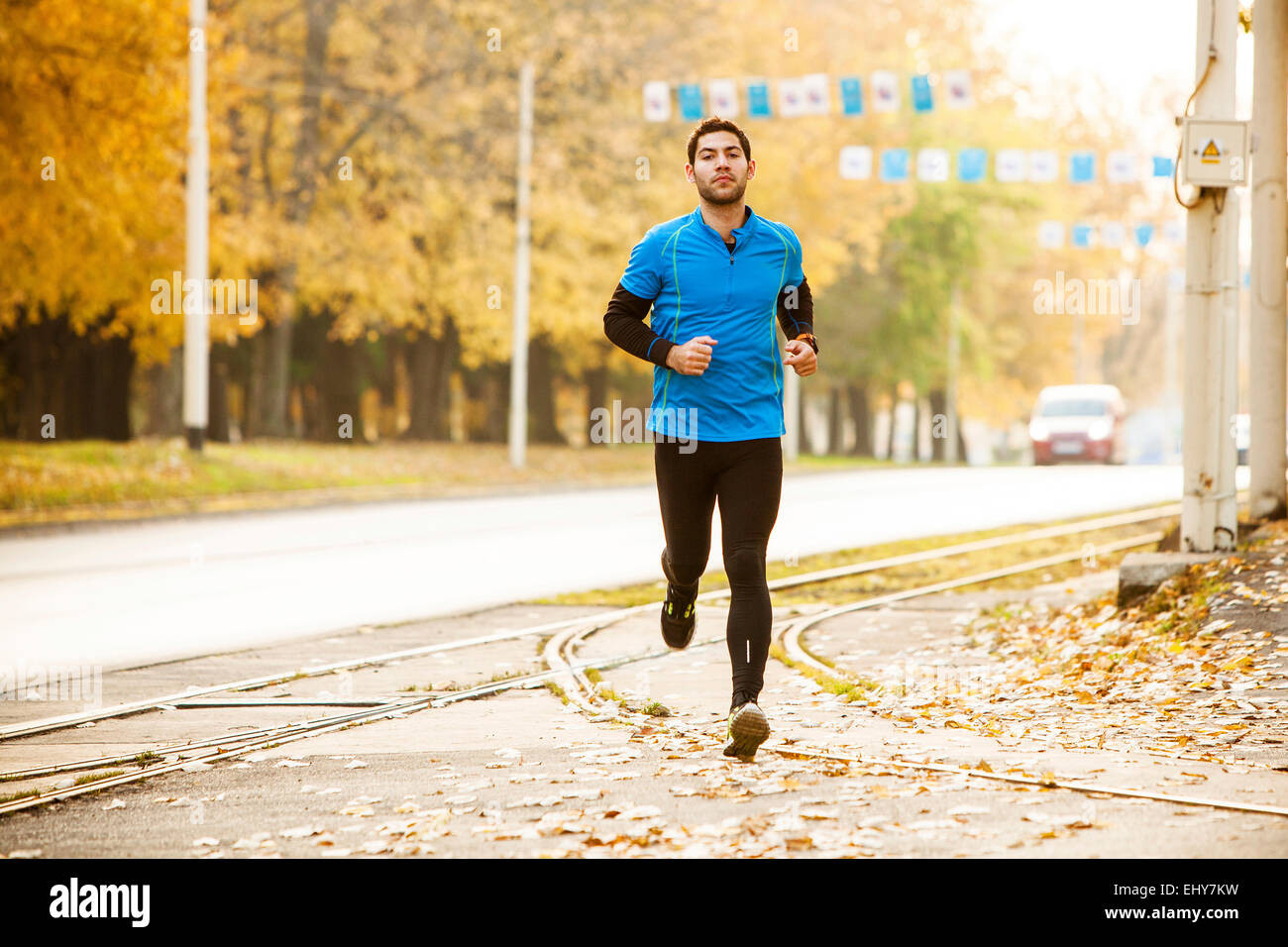 Young men on street running hi-res stock photography and images - Alamy