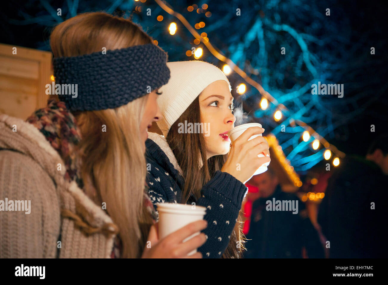 Two women drinking punch at Christmas Market Stock Photo - Alamy