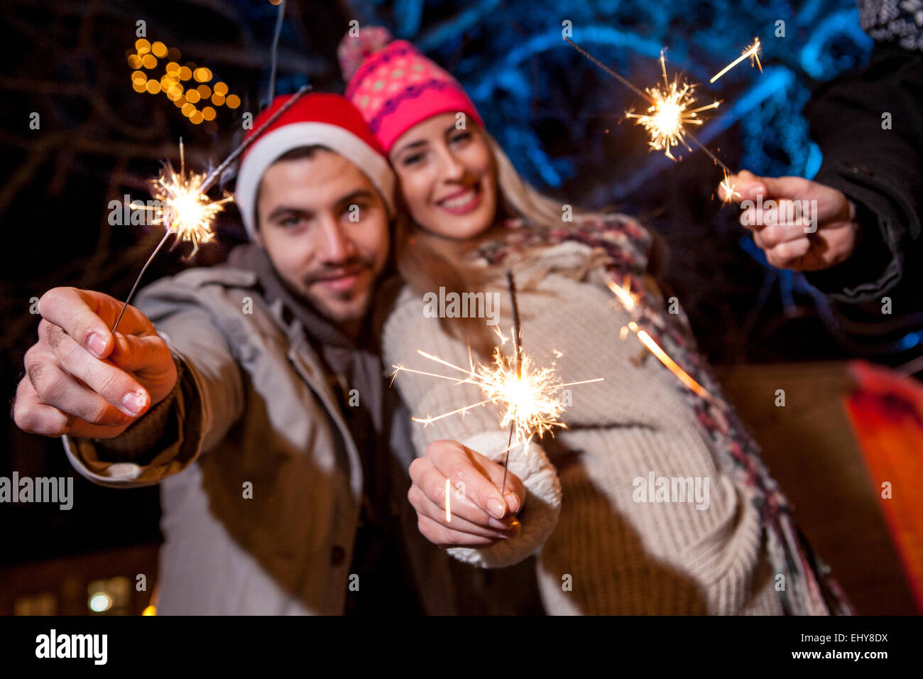Group of friends with sparklers having fun Stock Photo - Alamy