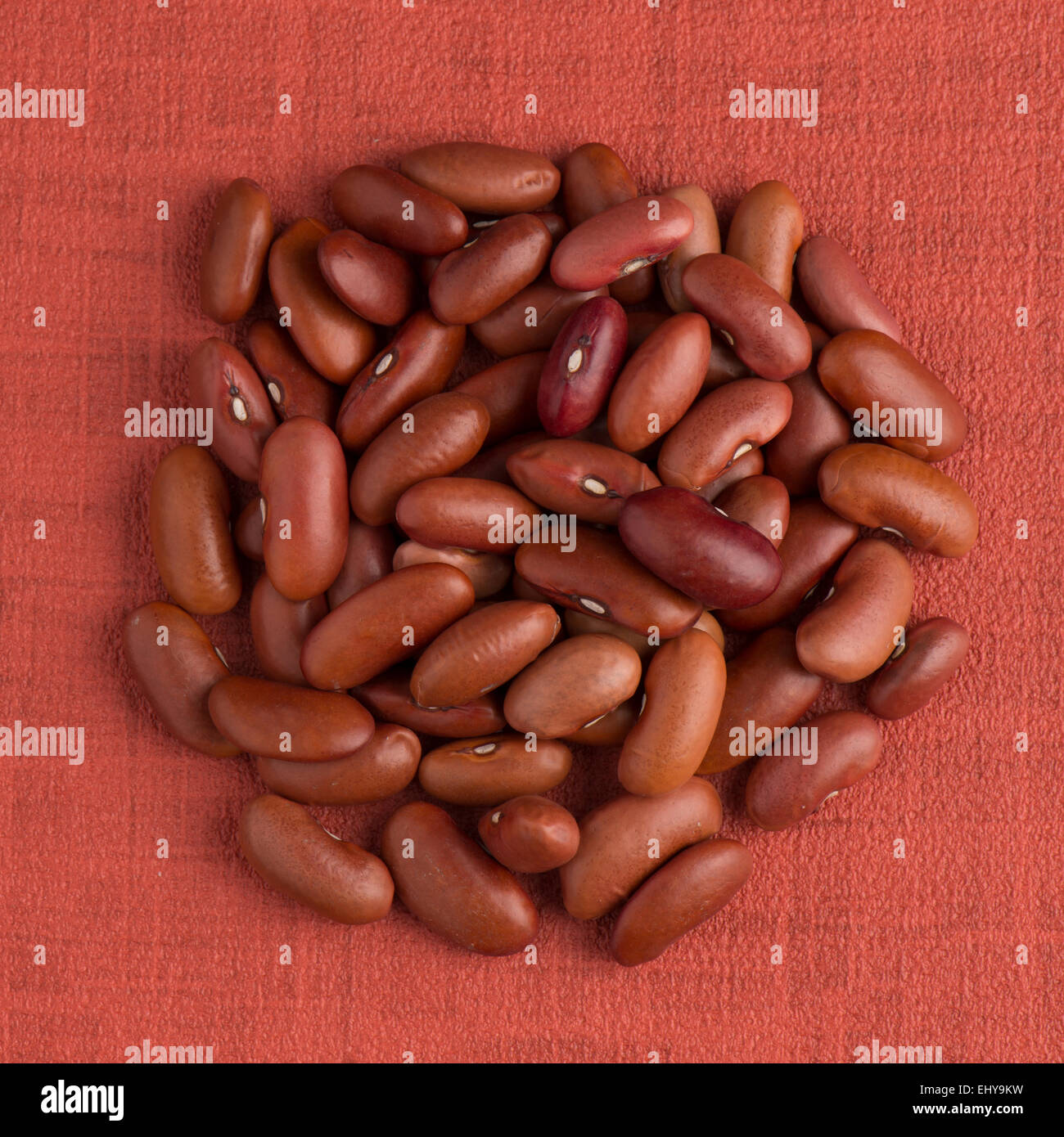 Circle of red beans on red vinyl background Stock Photo - Alamy