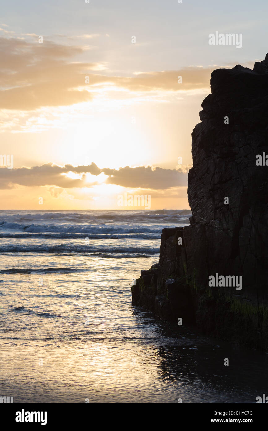 Beach sunrise with sea waves and shadow rock Stock Photo - Alamy