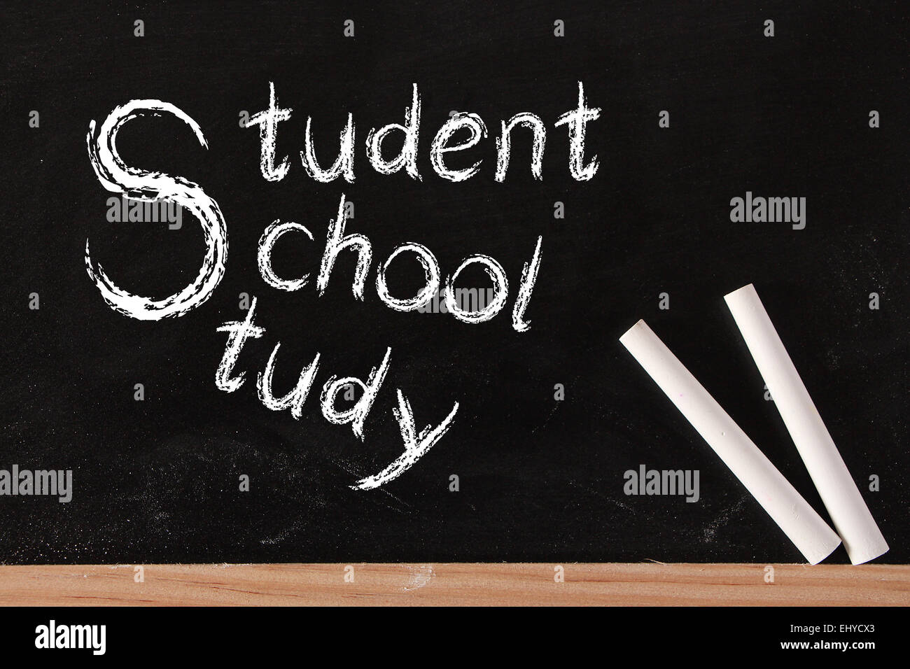 Student, School and Study written on blackboard with two white chalks ...