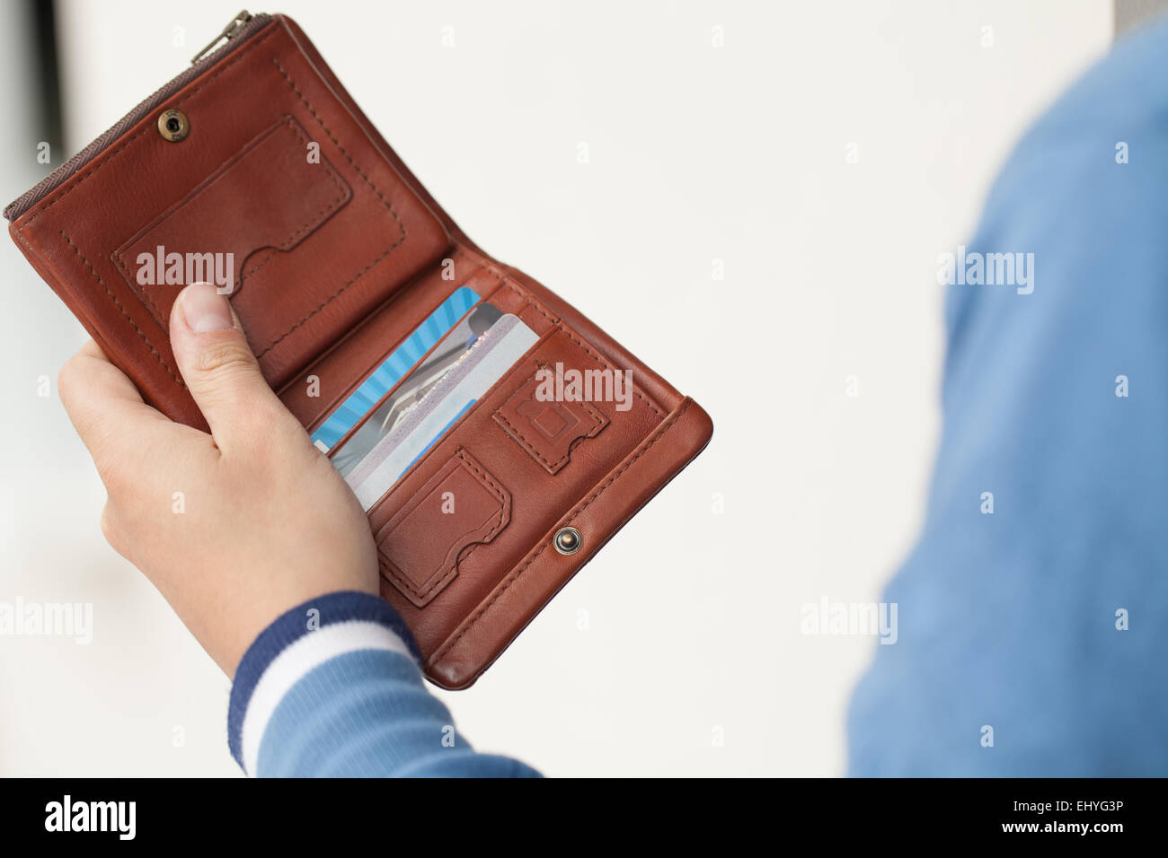 Open brown purse in male hands Stock Photo - Alamy