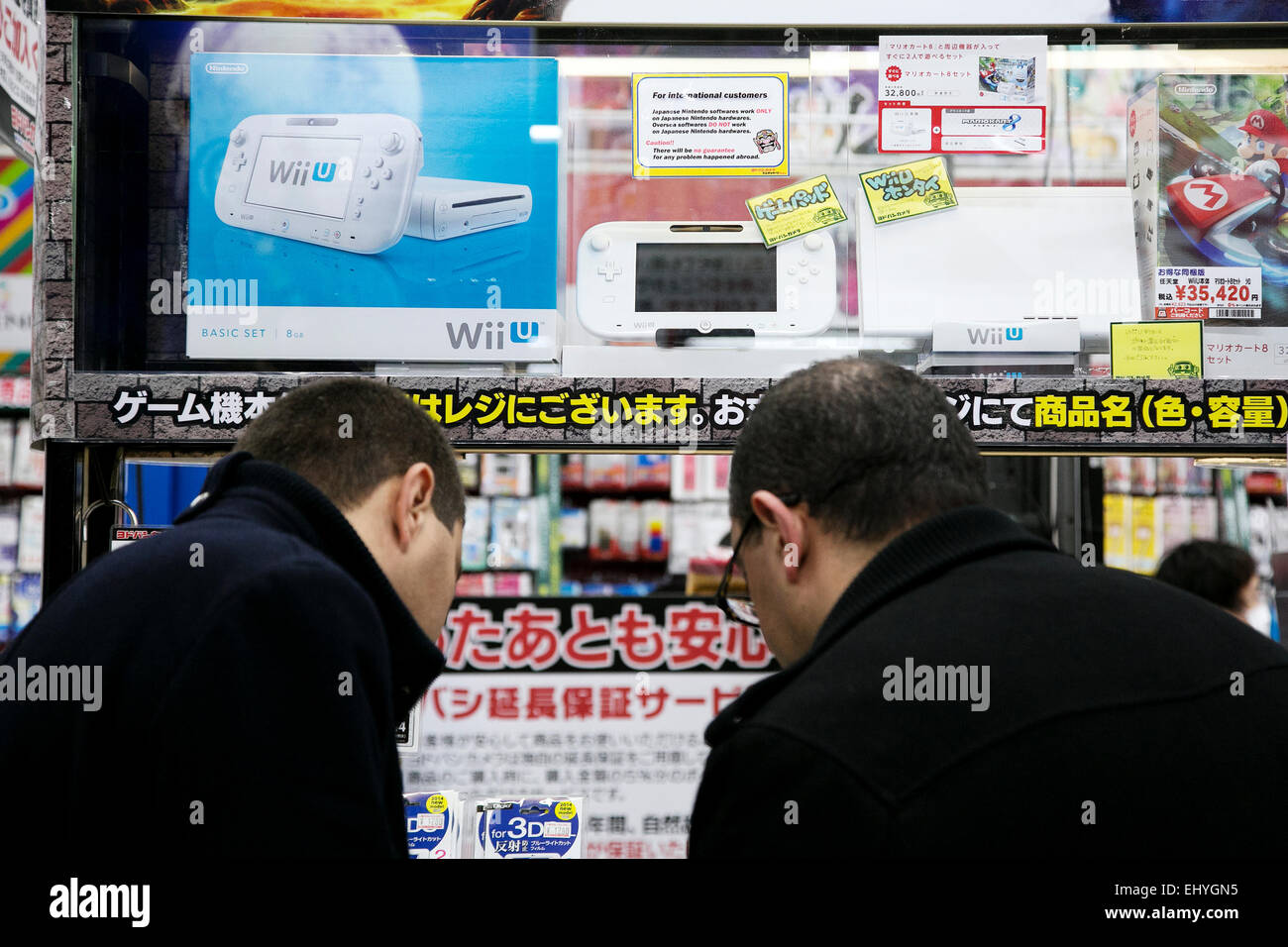 Shoppers check Nintendo consoles at an electronics shop in Akihabara ...