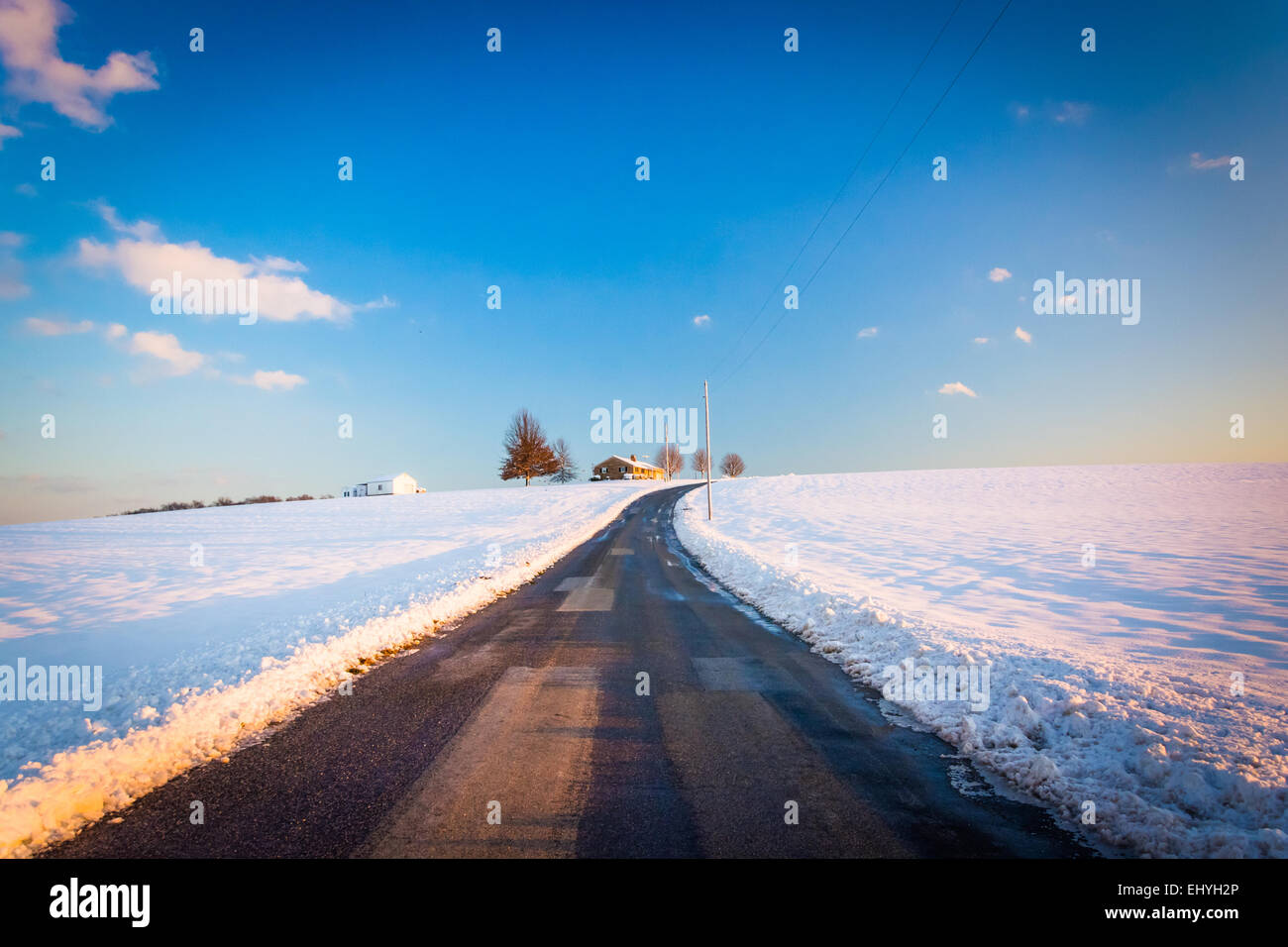Country road and snow covered farm fields in rural York County ...
