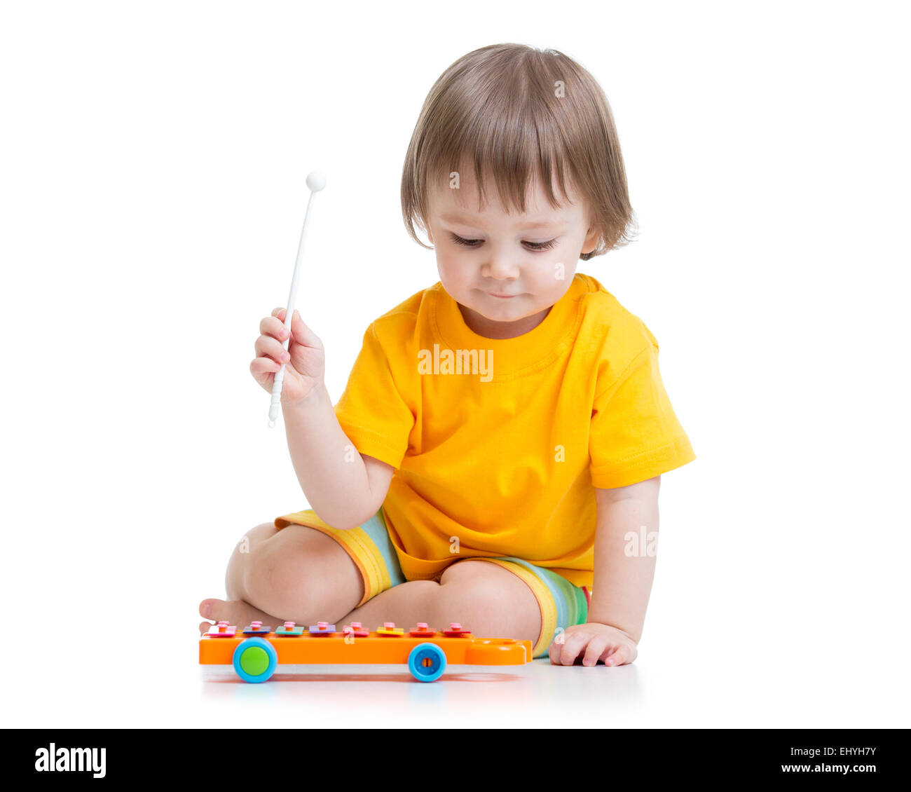 smiling child playing with musical toy Stock Photo - Alamy