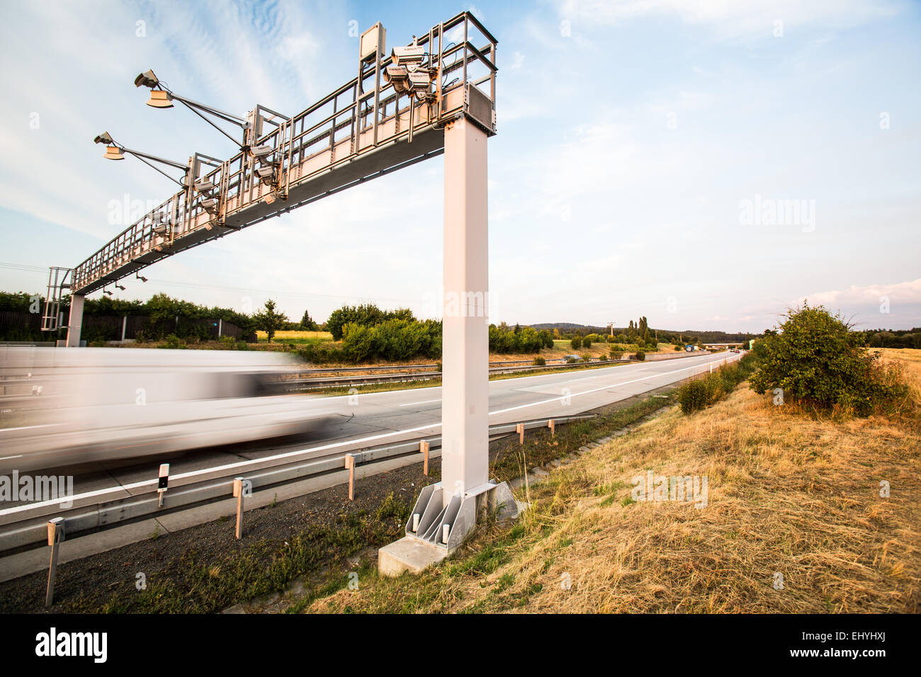 truck passing through a toll gate on a highway (motion blurred image ...