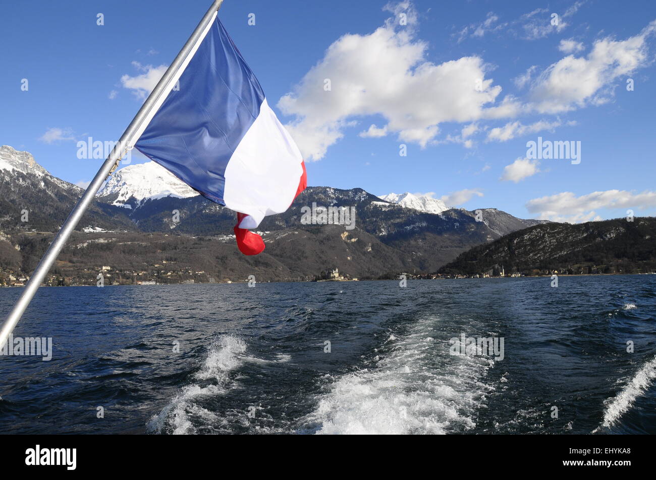 Annecy Lake and mountains from boat and French flag Stock Photo - Alamy
