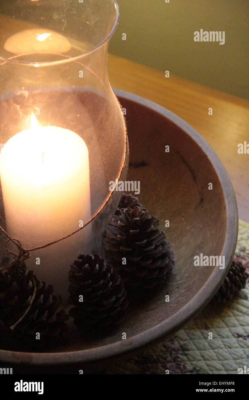 Candle with pine cones in a bowl Stock Photo - Alamy