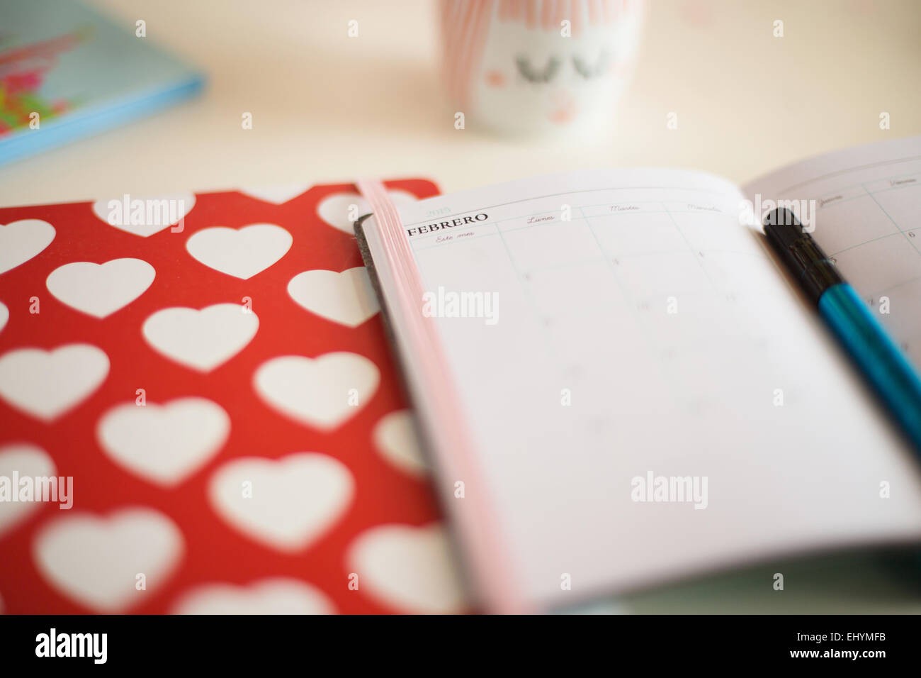 Open diary on a table Stock Photo - Alamy