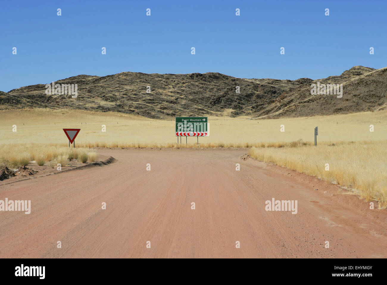 Landscape with road signs to Burnt Mountain, Namibia Stock Photo - Alamy