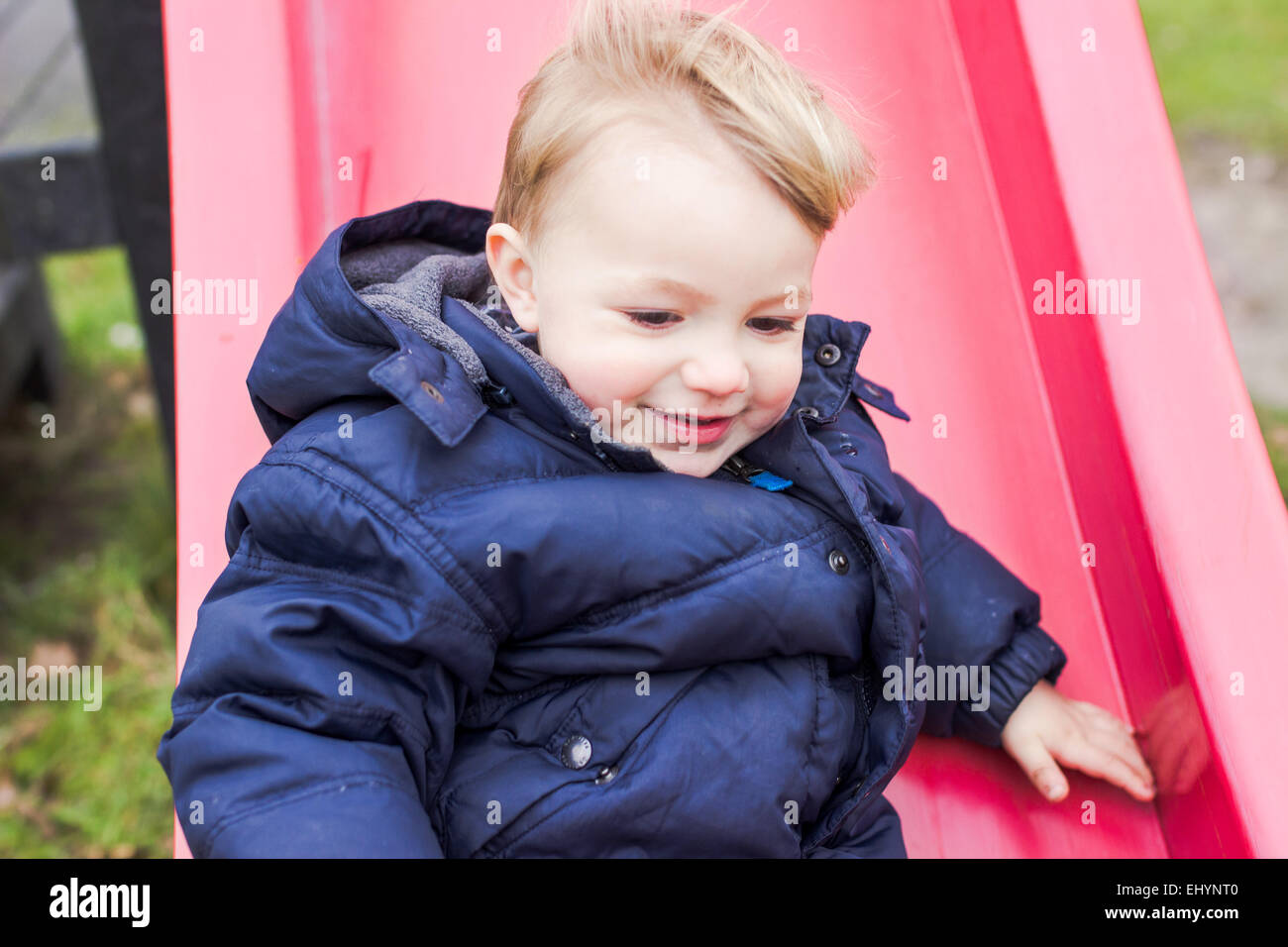 Baby boy on slide Stock Photo - Alamy