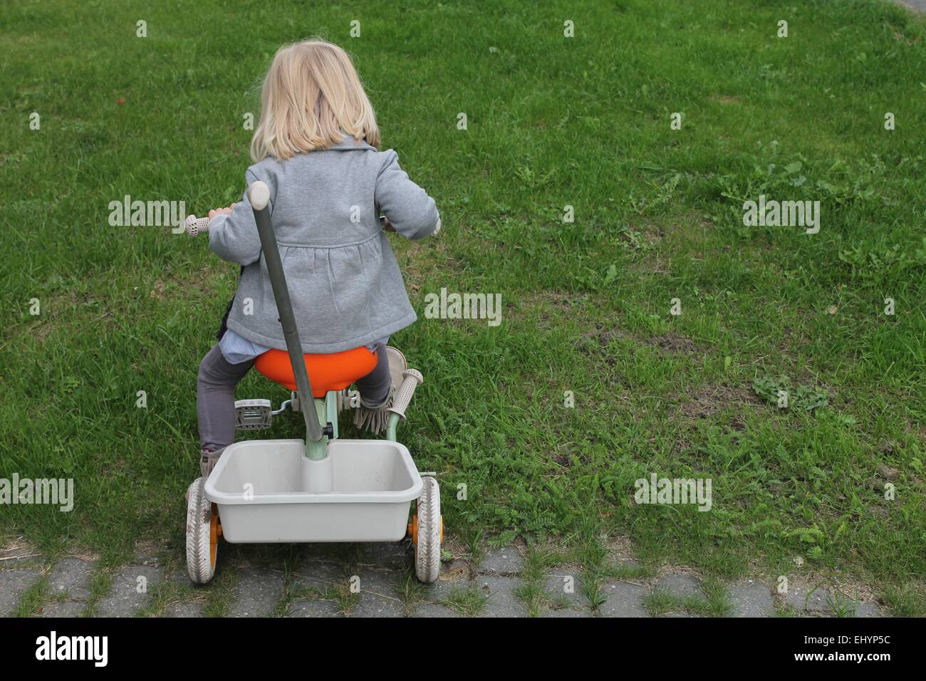 Girl on tricycle hi-res stock photography and images - Alamy