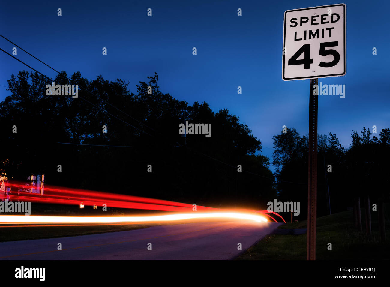 Long exposure of cars passing by a speed limit sign Stock Photo - Alamy