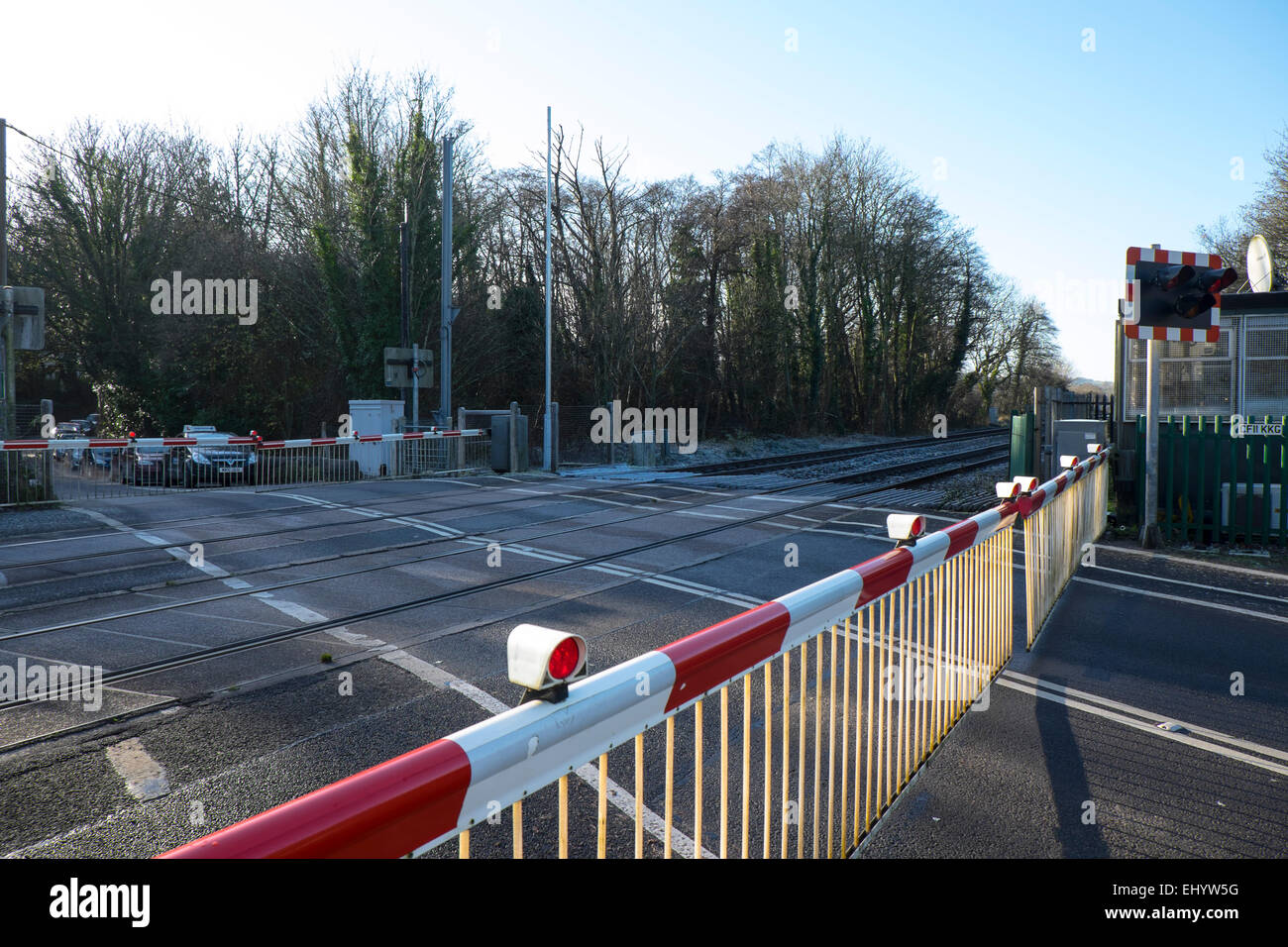 Gates closed at level crossing, railway line, St Fagan's, Cardiff ...