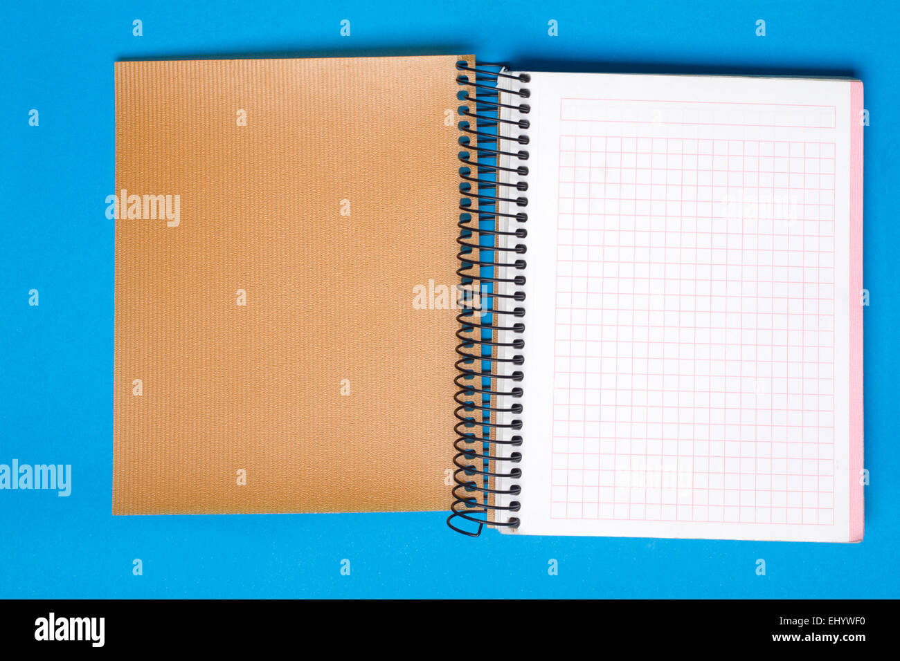 Small notebook over a blue background Stock Photo - Alamy