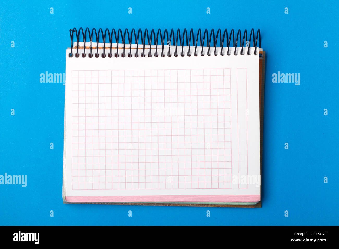 Small notebook over a blue background Stock Photo - Alamy