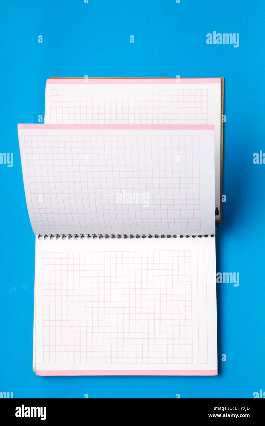 Small notebook over a blue background Stock Photo - Alamy