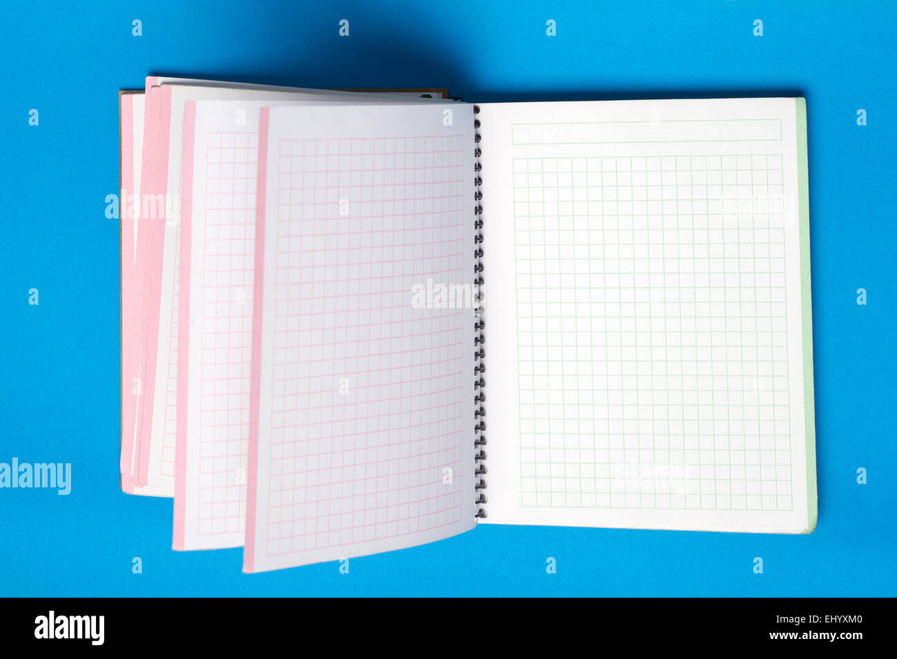 Small notebook over a blue background Stock Photo - Alamy