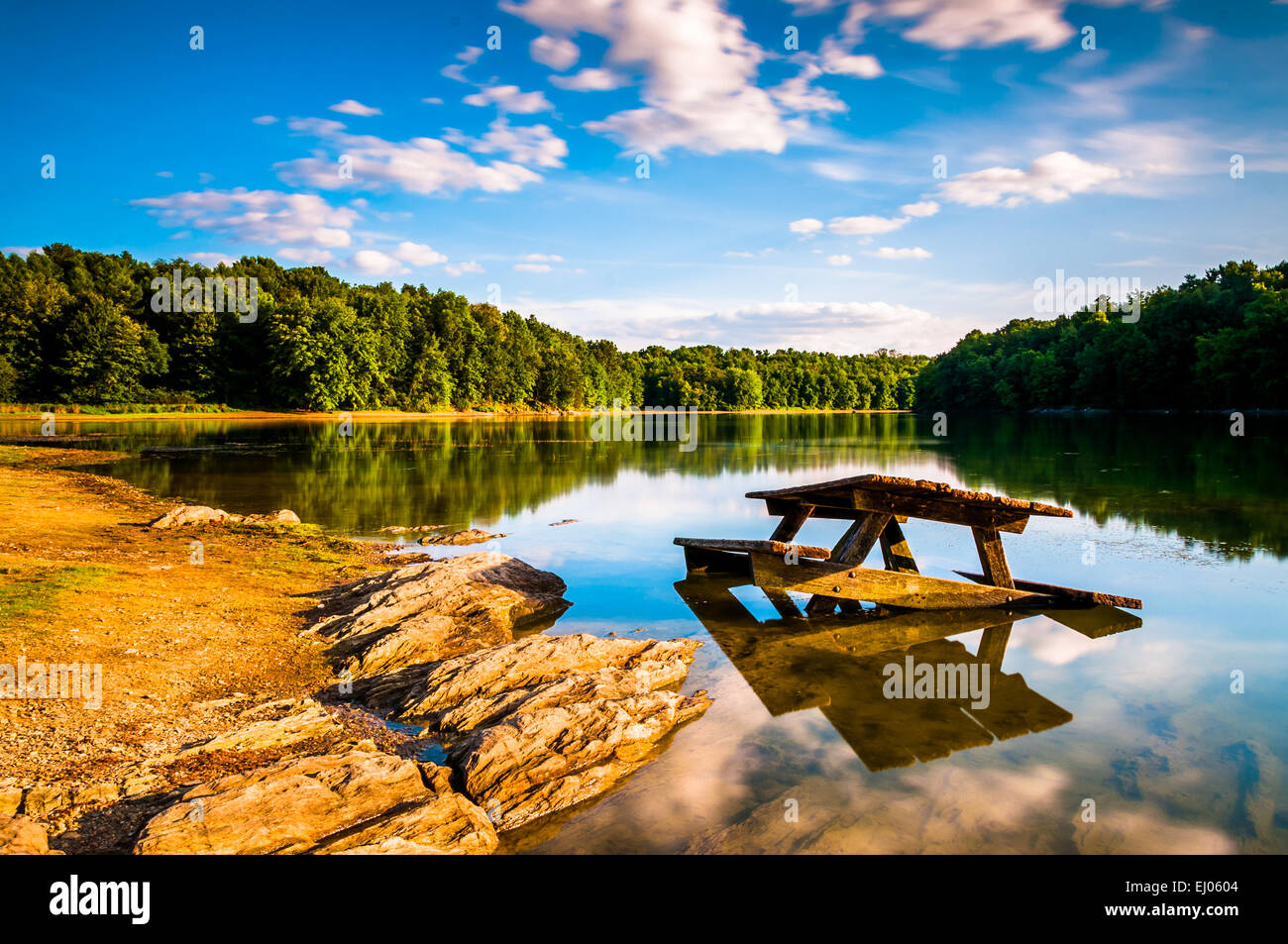 Rocks and a picnic table in Lake Marburg, at Codorus State Park ...