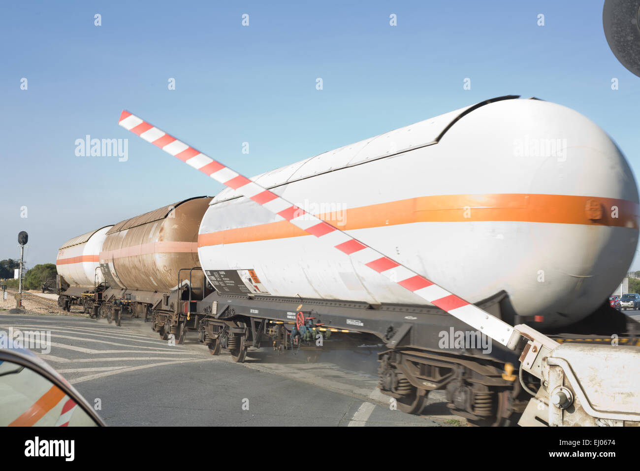 Merchandise wagon with oil tanks crossing on the road Stock Photo - Alamy