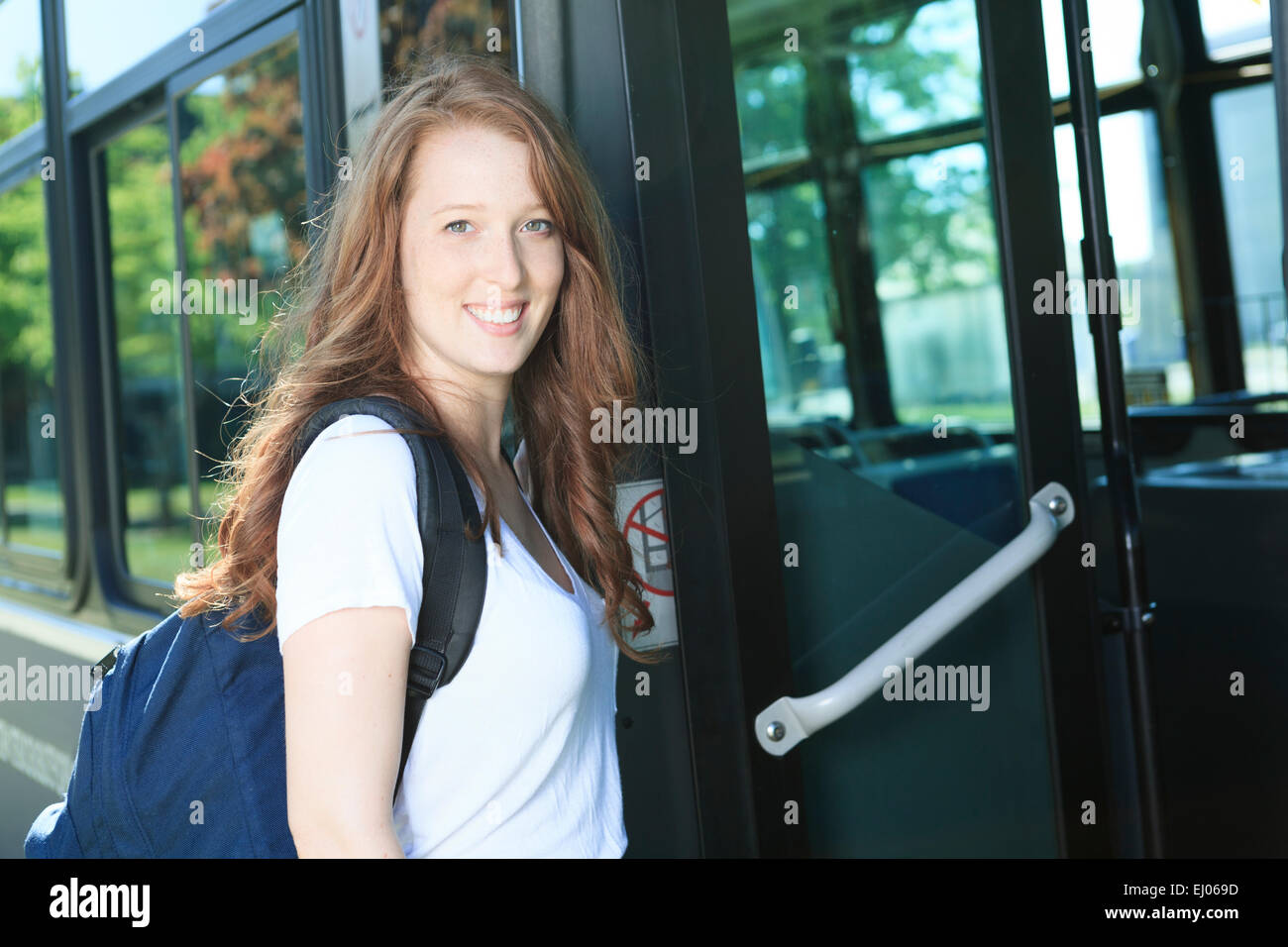 University / college student girl looking happy smiling with boo Stock ...