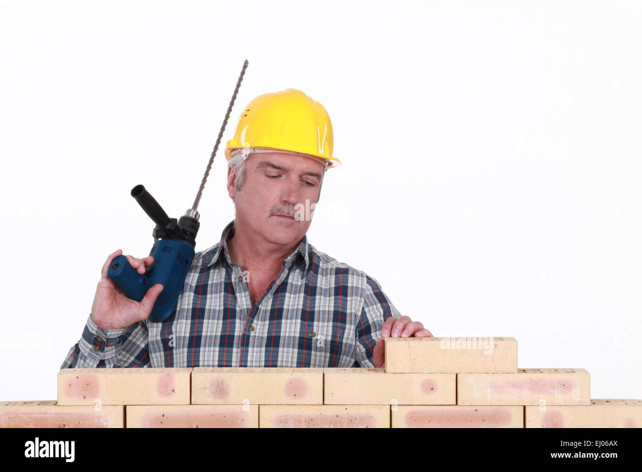 A mason with a drill Stock Photo - Alamy