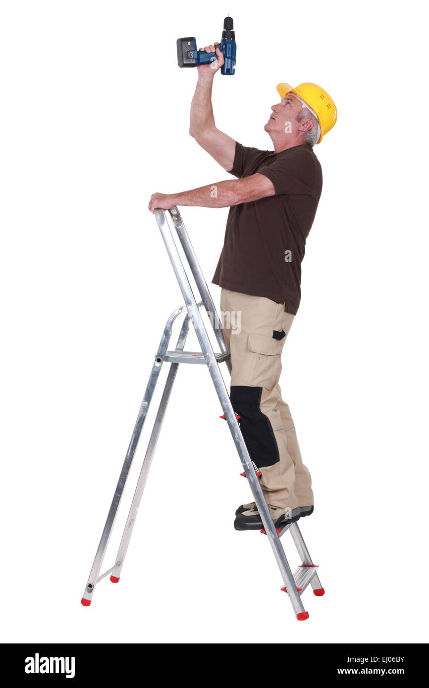 Handyman drilling the ceiling Stock Photo - Alamy