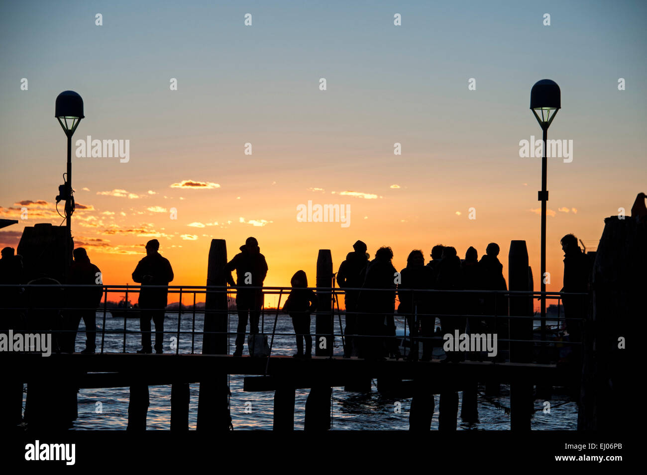 People watching the sunset from a pier on the Zattere Promenade Stock ...
