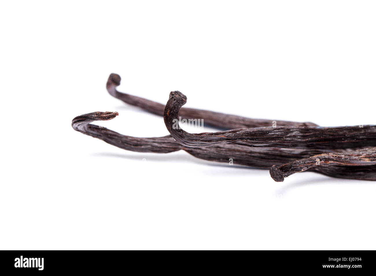 Close view of vanilla pods over a white background Stock Photo - Alamy