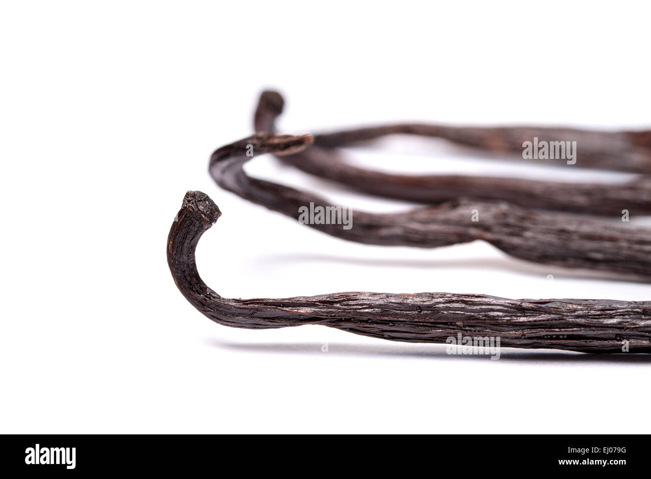 Close view of vanilla pods over a white background Stock Photo - Alamy