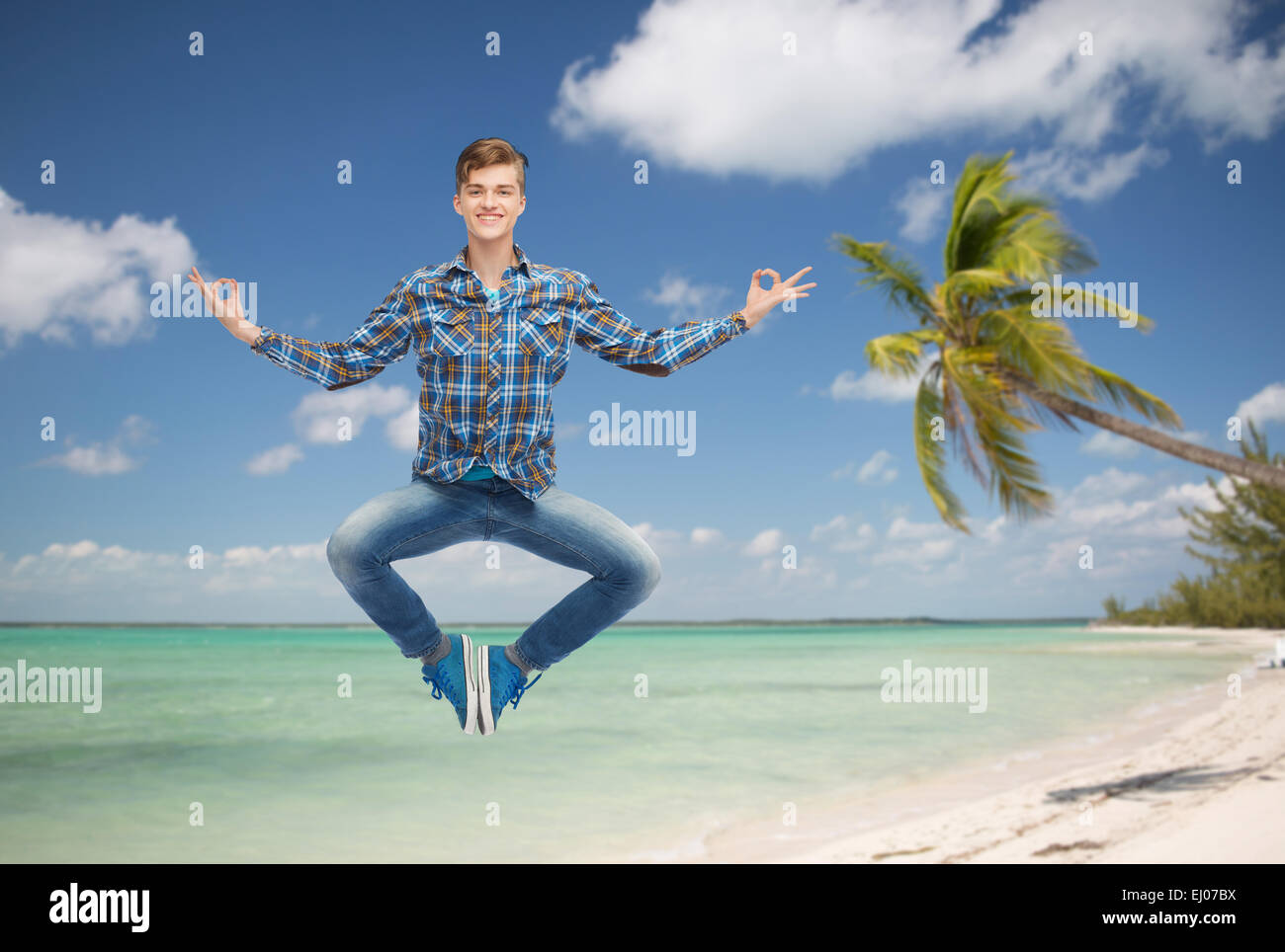 smiling young man jumping in air Stock Photo - Alamy