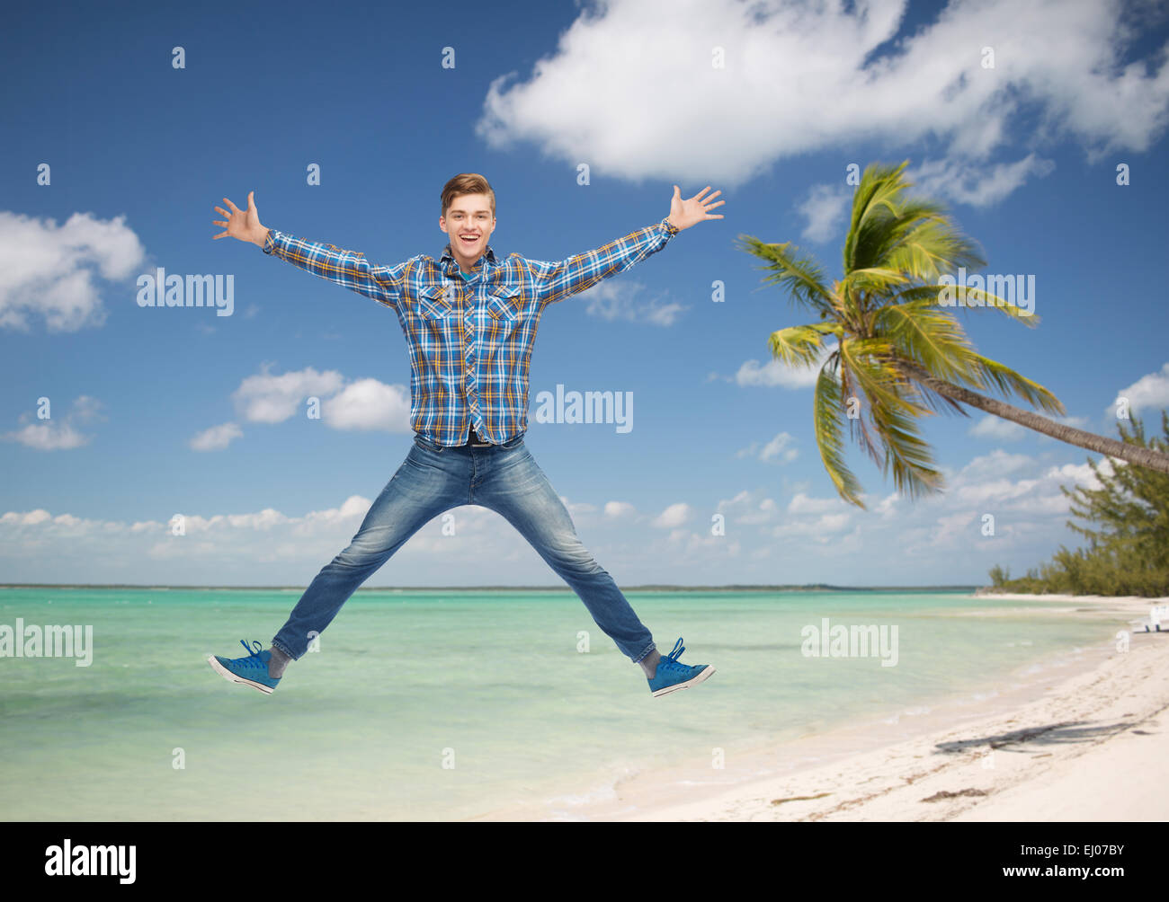 smiling young man jumping in air Stock Photo - Alamy