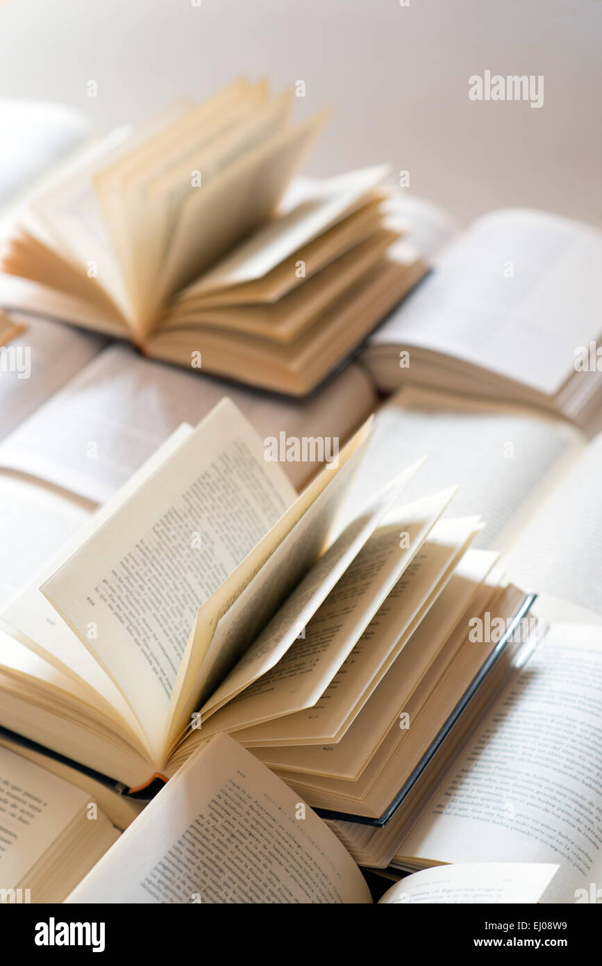 Many open books piled up. unreadable text. Copy space Stock Photo - Alamy