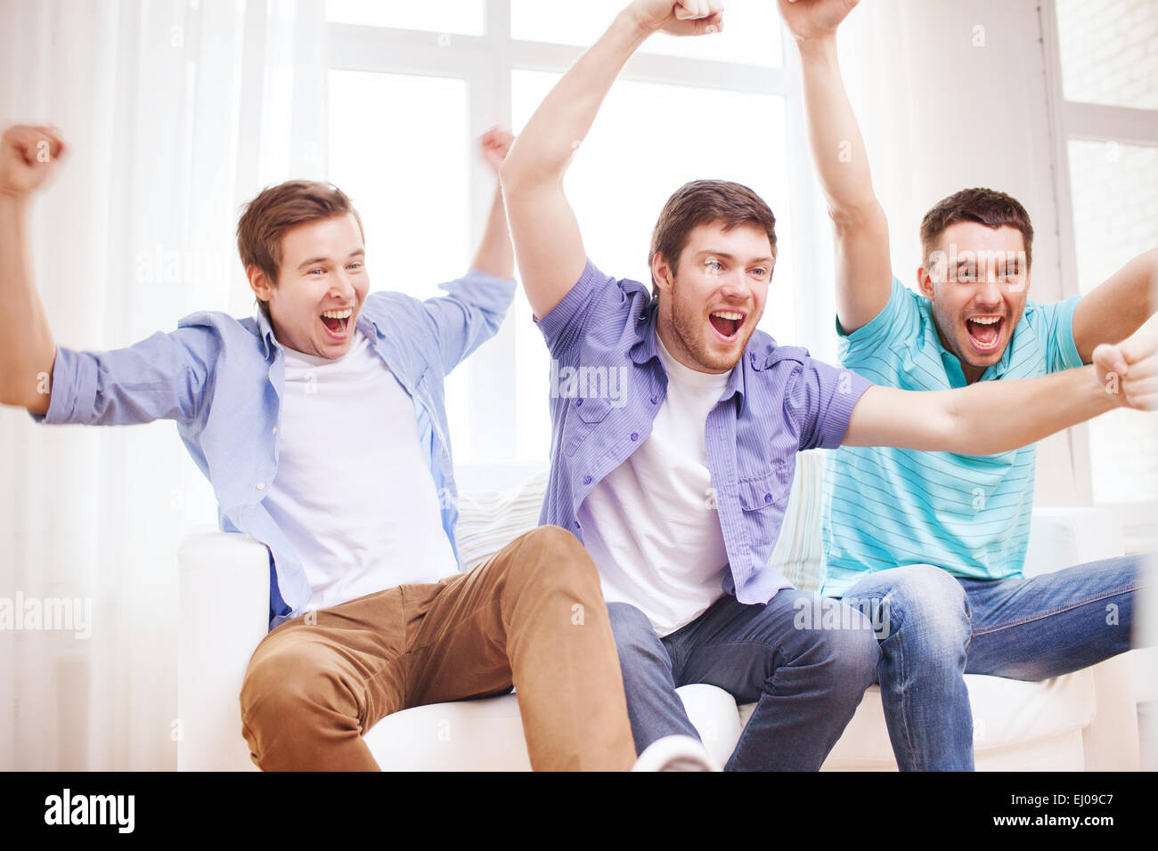 happy male friends at home Stock Photo - Alamy