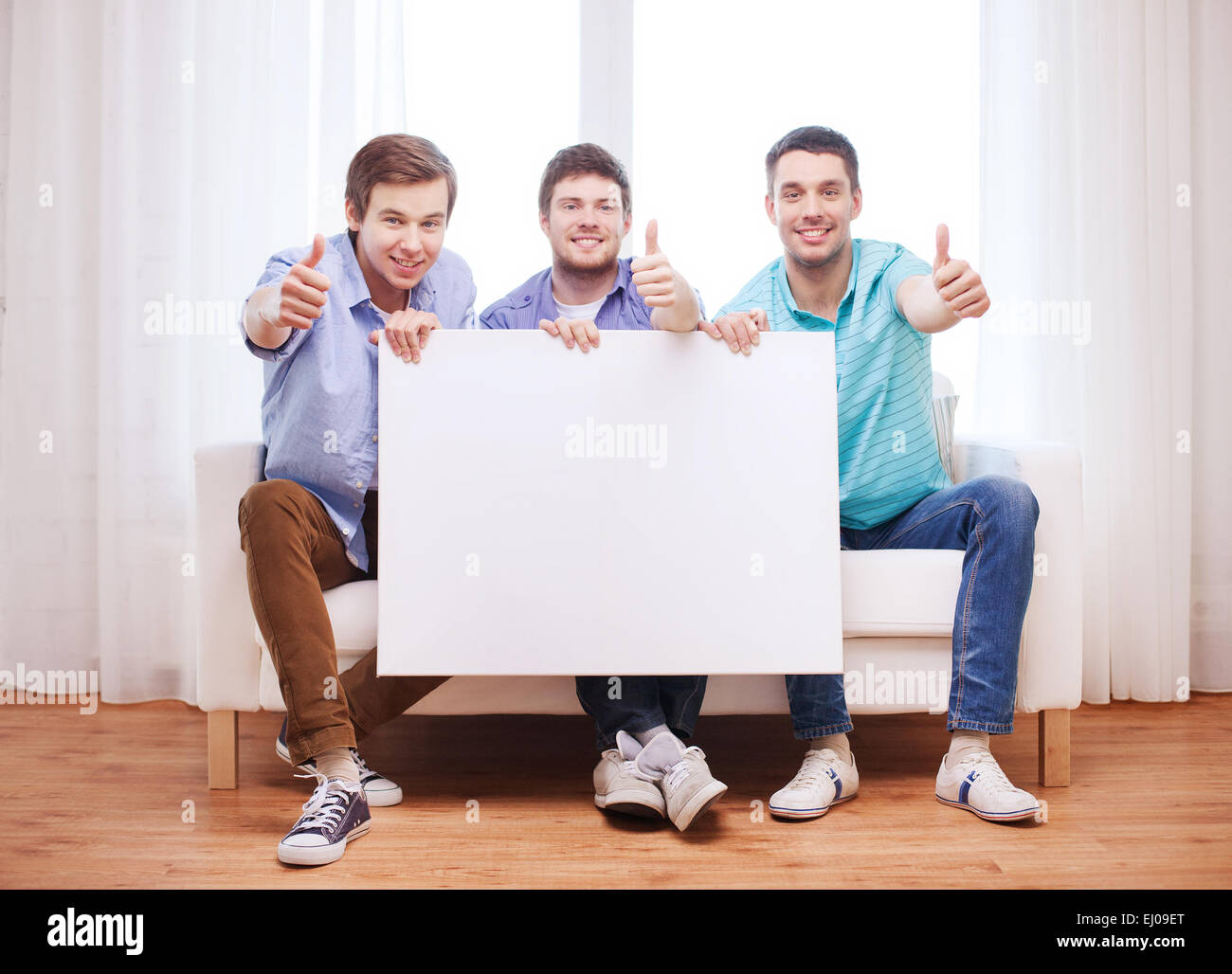 happy male friends with blank white board Stock Photo - Alamy