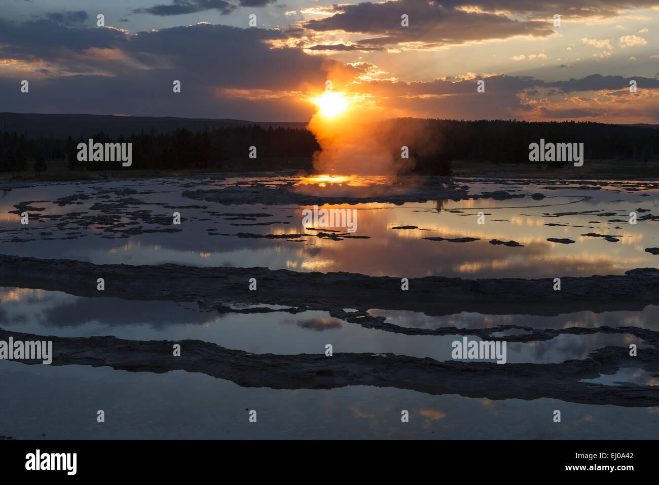 Great Fountain Geyser, in the Lower Geyser Basin, by sunset ...