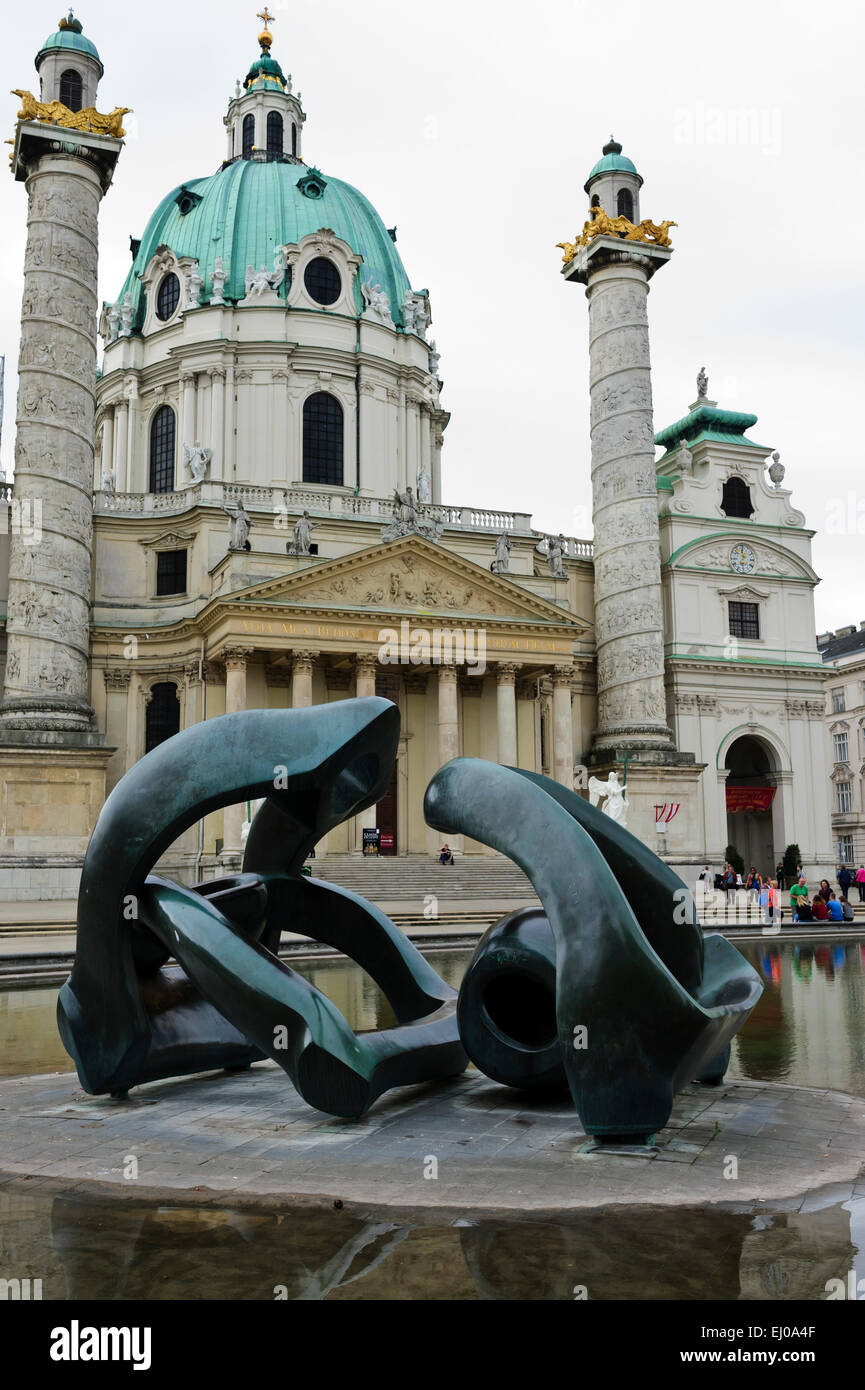 The exterior of Karlskirche church with two tall stone carvings columns ...