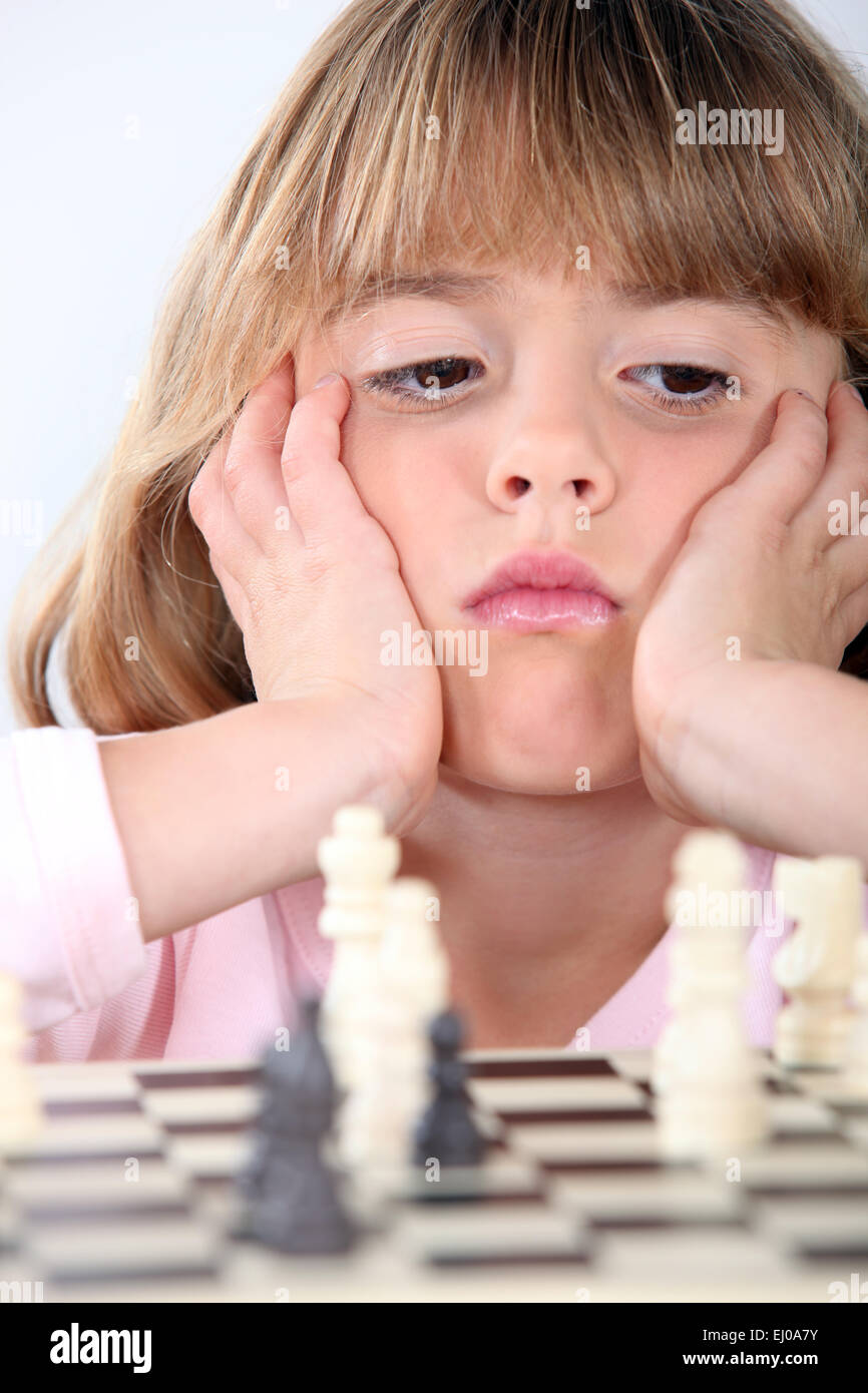 Little girl playing chess Stock Photo - Alamy