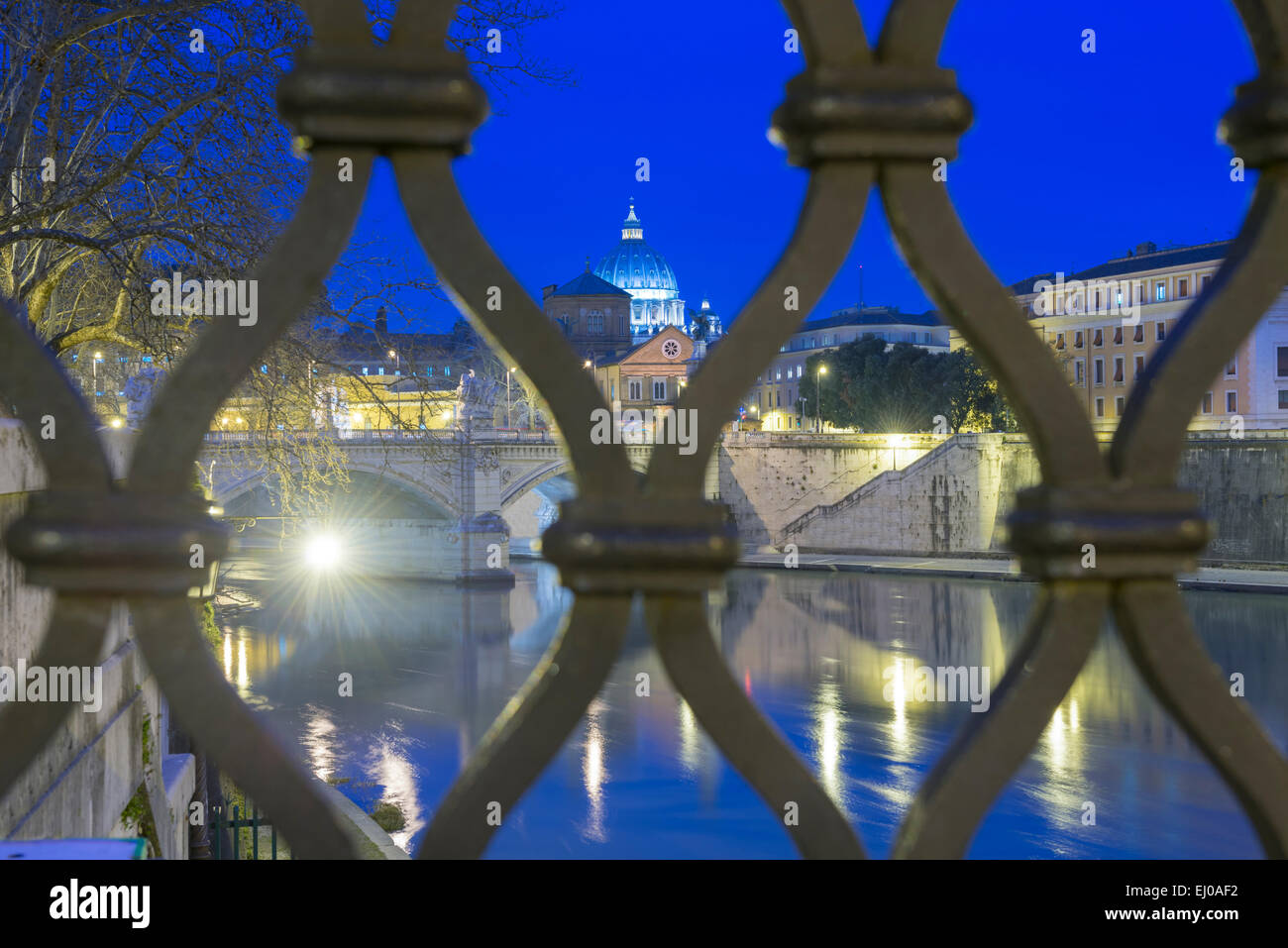River tiber and Basilica di San Pietro in blue hour and behind a fence ...