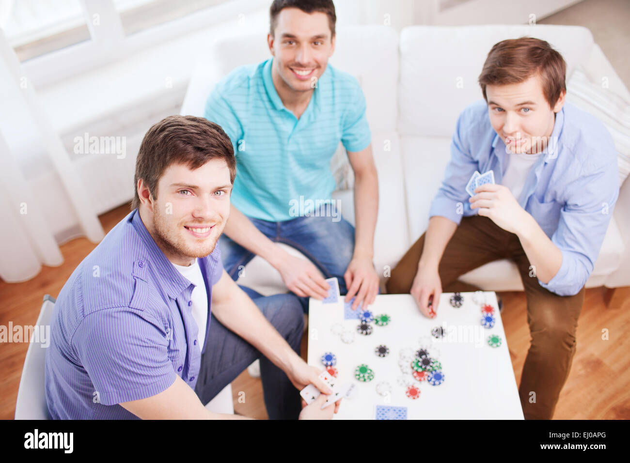 Three friends playing cards hi-res stock photography and images - Alamy