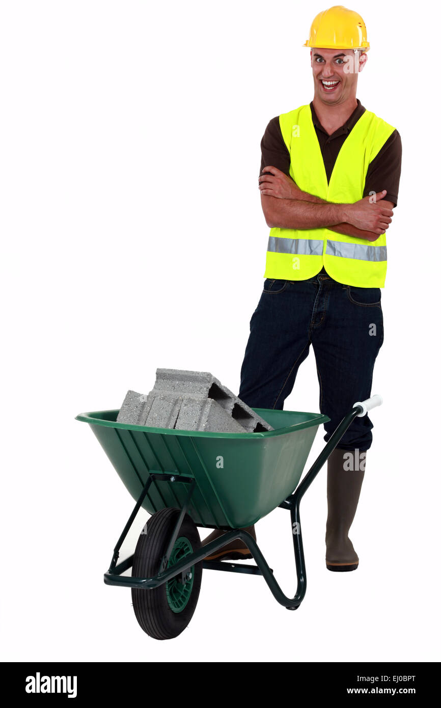 A mason with a wheelbarrow Stock Photo - Alamy