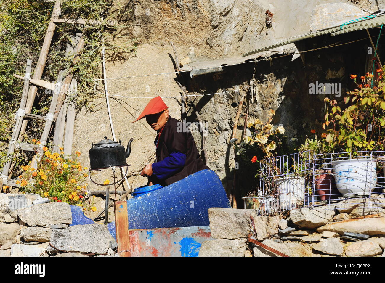 DREPUNG, TIBET, CHINA - OCTOBER 19: Tibetan buddhist nun prepares tea ...