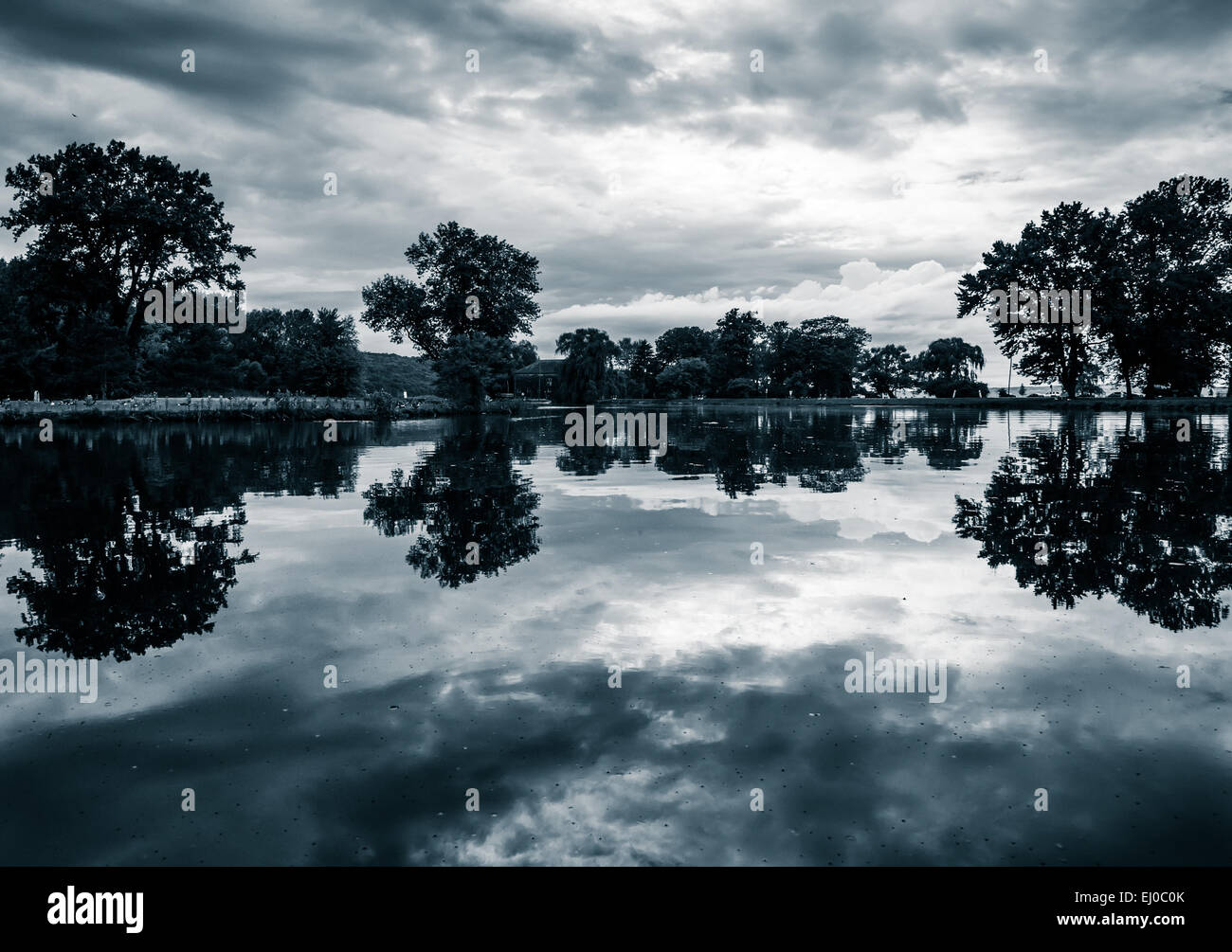 Storm clouds reflect in a pond at Stewart Park in Ithaca, New York ...