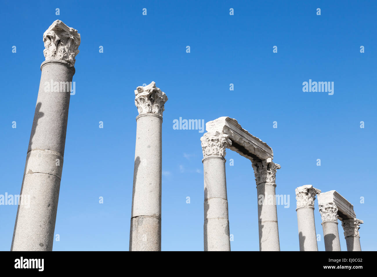 Ancient columns in a row on blue sky background, fragment of ruined ...