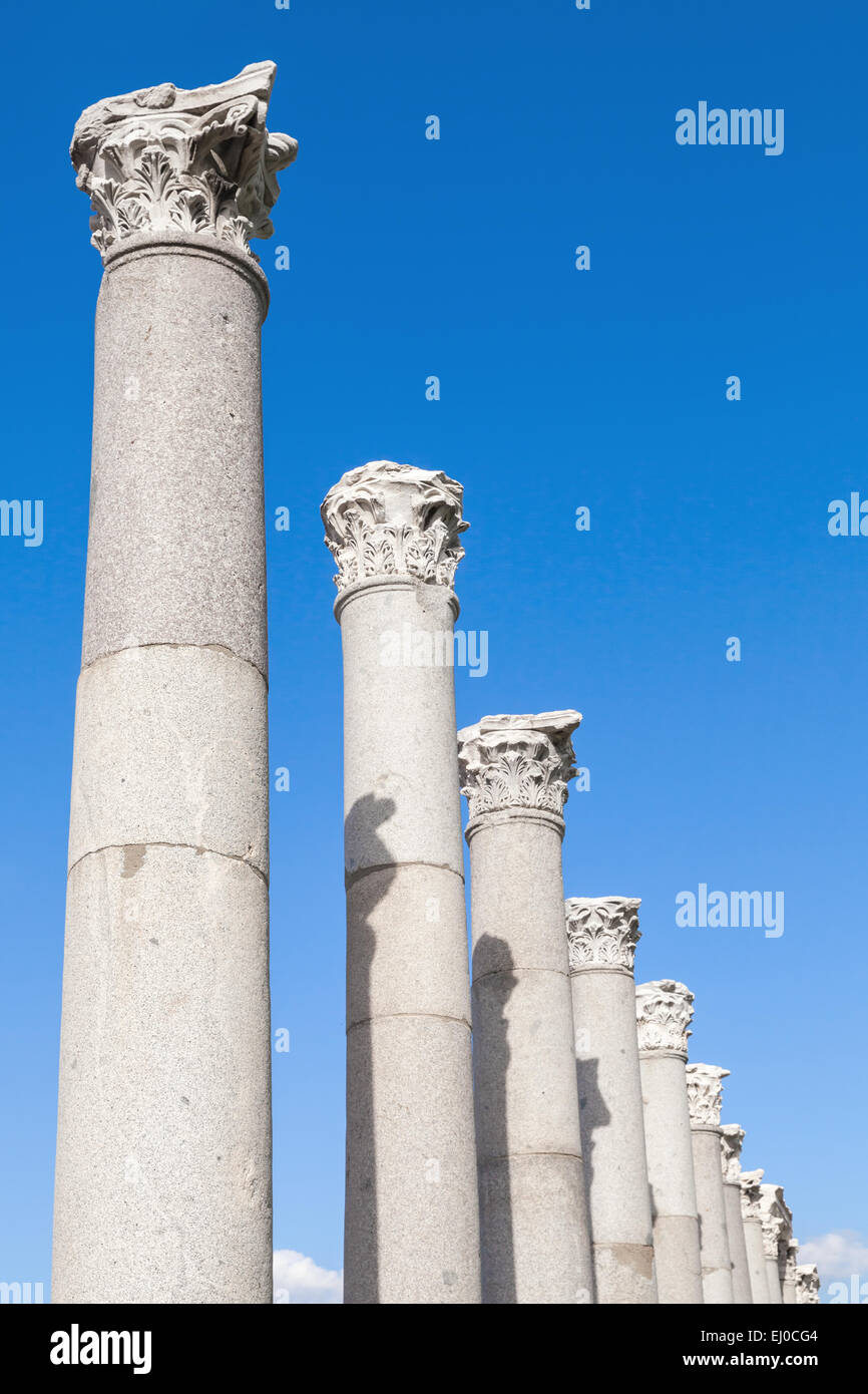 Ancient columns on blue sky background, fragment of ruined roman temple ...