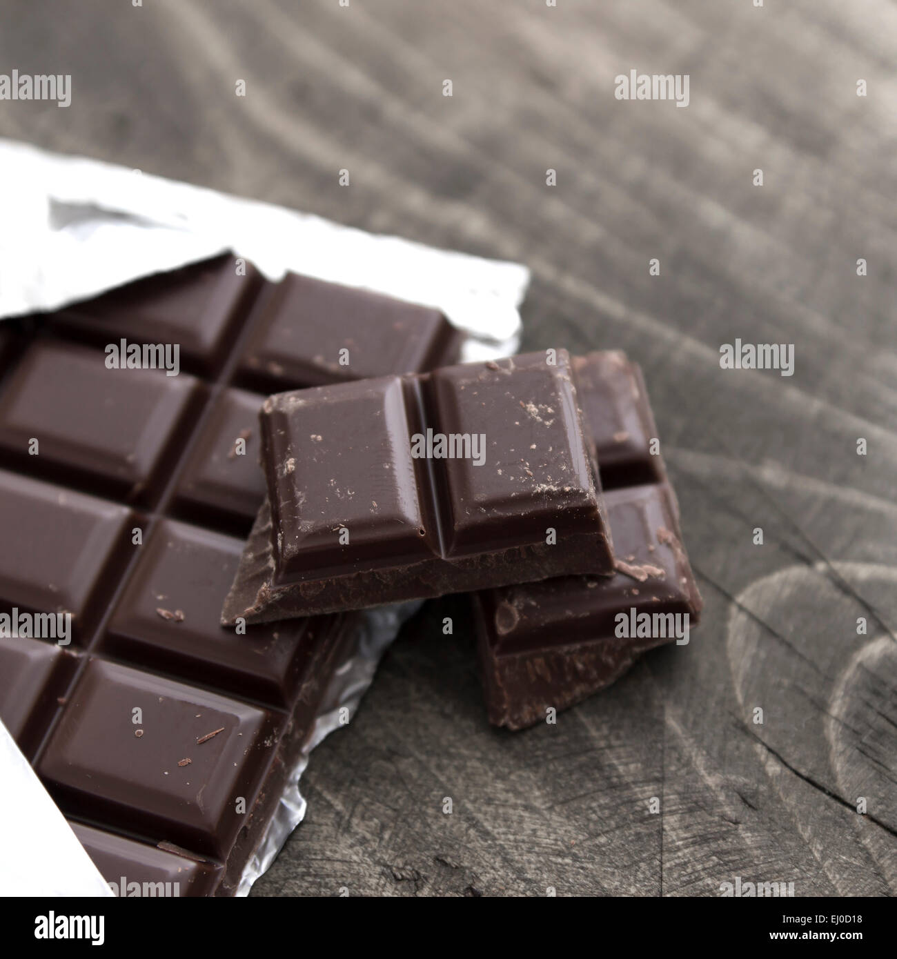 Chocolate Bar on wooden table, close up Stock Photo - Alamy